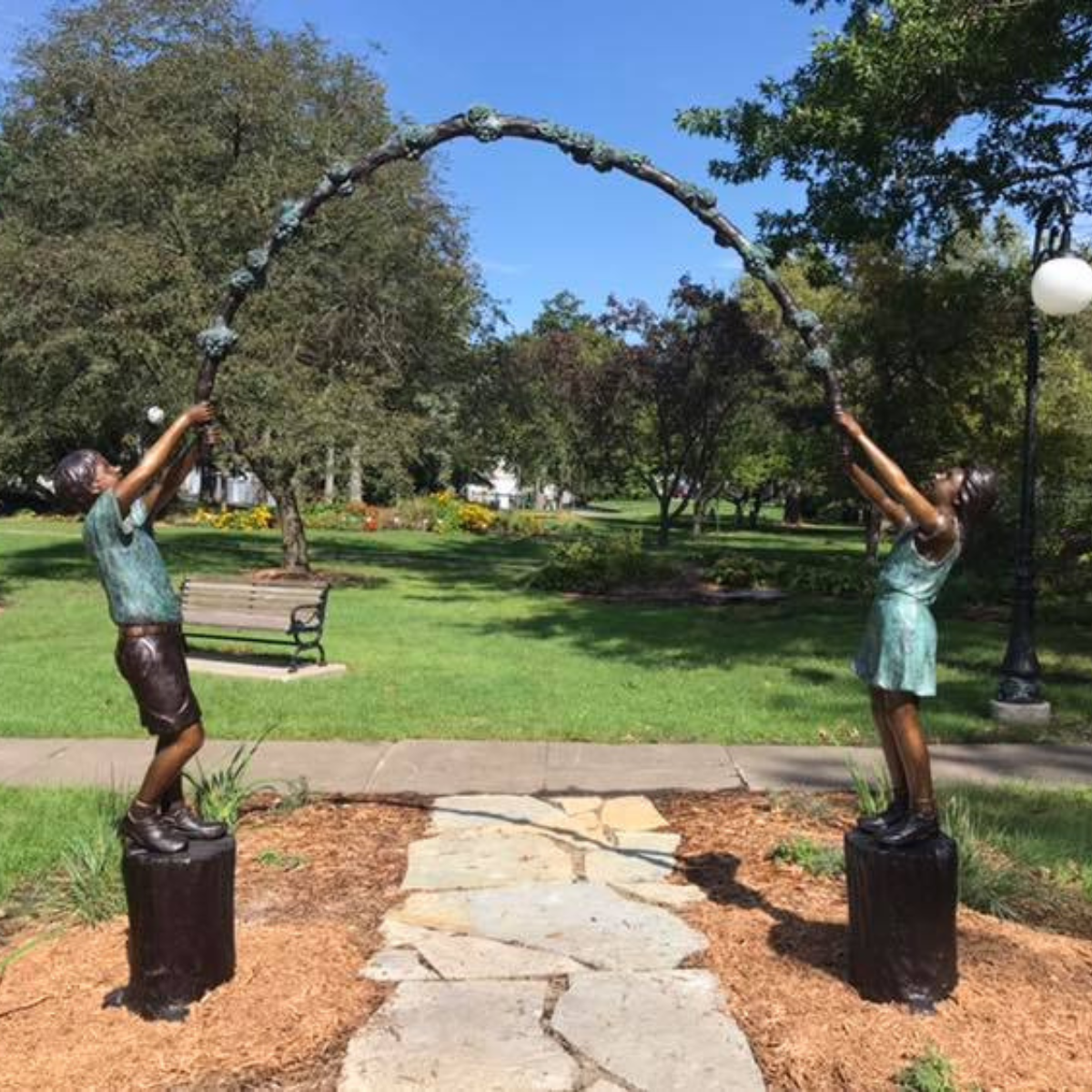 Bronze Garden Statue Of Kids Holding an Arbor | Randolph Rose Collection